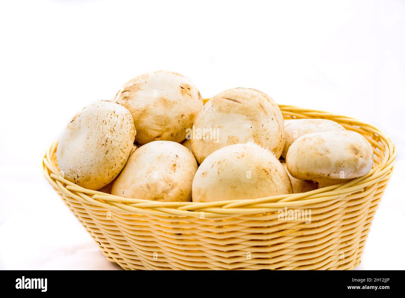 Fresh champignons, champignon mushrooms in wicker basket isolated Stock ...