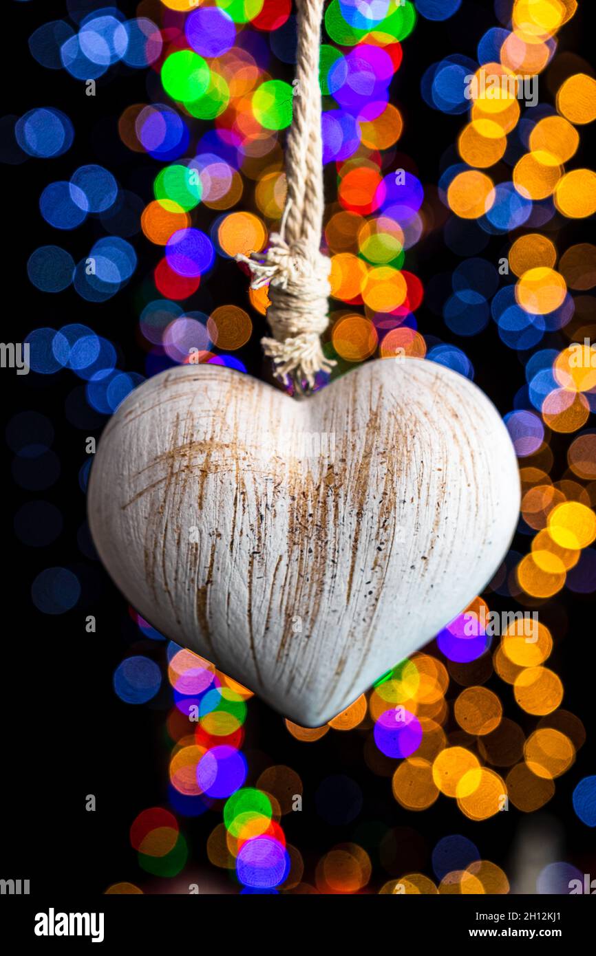 Holding Christmas decoration against bokeh lights background Stock Photo - Alamy