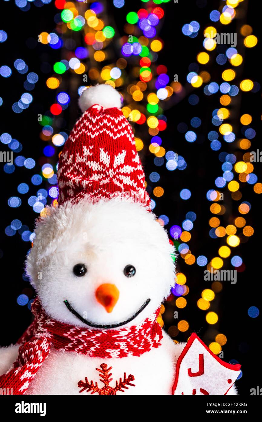 Holding Christmas decoration against bokeh lights background Stock Photo - Alamy