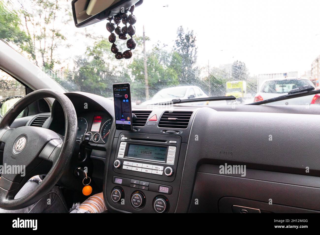 Using waze maps application on smartphone on car dashboard, Driver ...