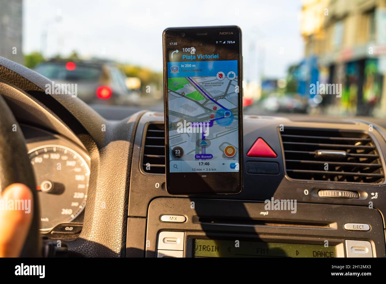 In car dashboard view with smartphone showing Police on Waze maps ...