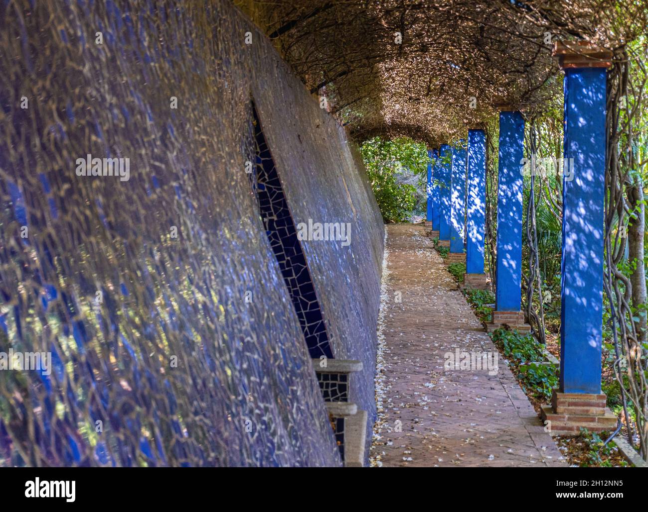 Beautiful scene of a garden with blue columns and mosaic walls Stock ...