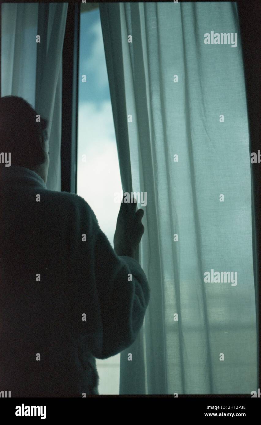 Moody silhouette of young lady in window book cover design Stock Photo ...