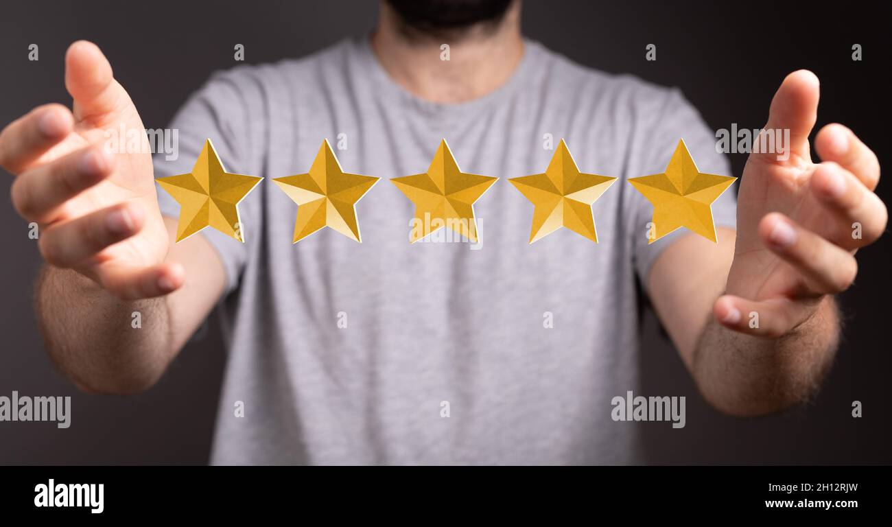 3D rendering of a five-stars rating hovering between man's hands Stock ...