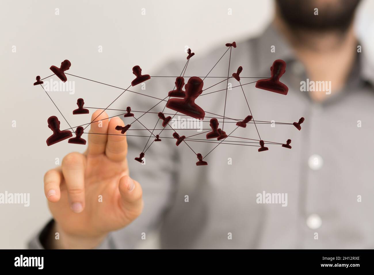 Person tapping floating 3D rendered red human icons Stock Photo - Alamy