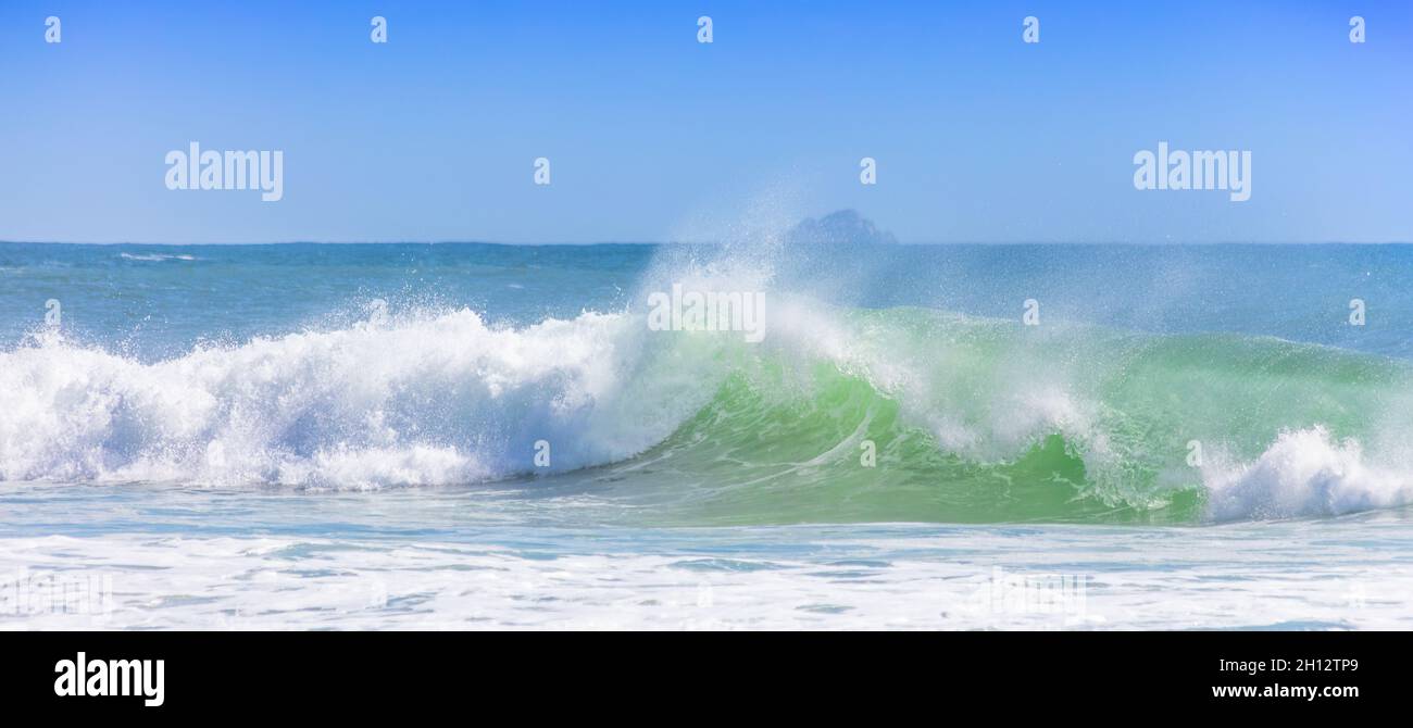 Beautiful beach landscape with waves and island Stock Photo - Alamy