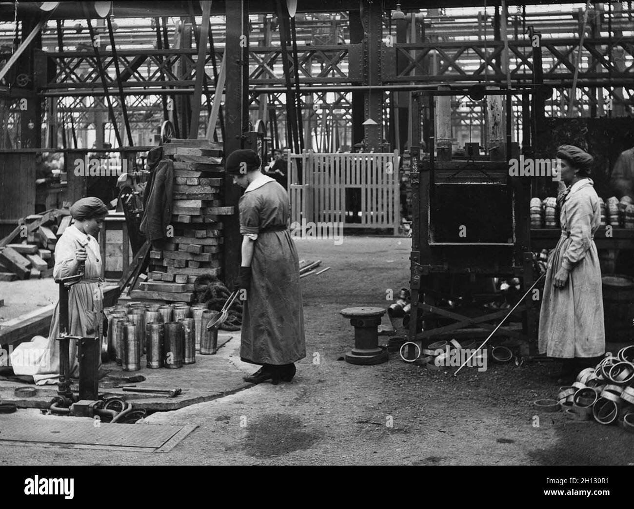 Workers assemble artillery shells in a factory during WW1 Stock Photo ...