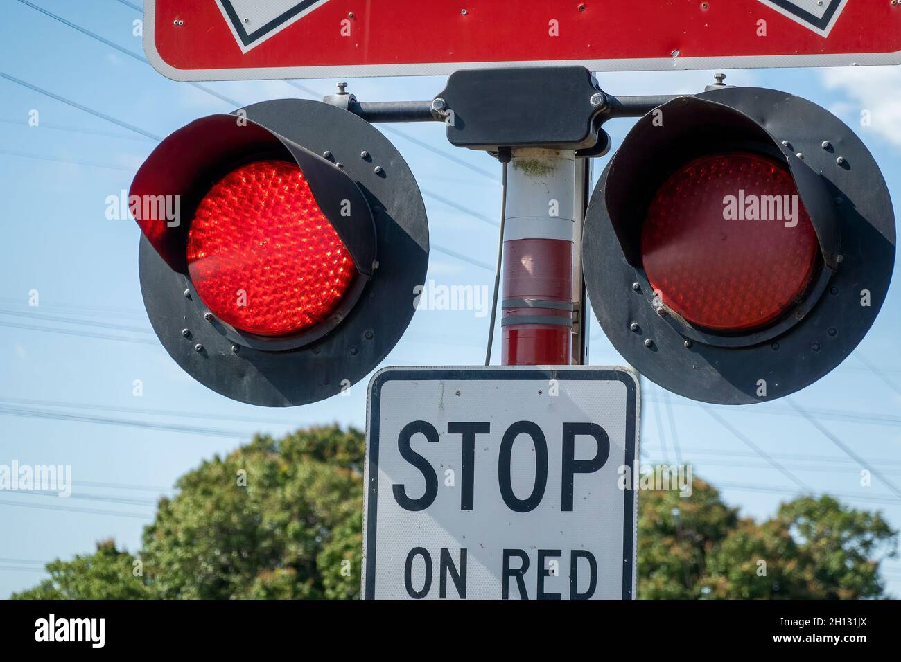 Close up of railway crossing stop go sign with red signal on Stock ...