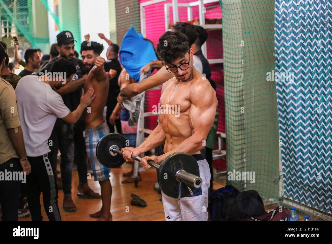 Gaza, Palestine. 15th Oct, 2021. An athlete seen lifting weights during ...
