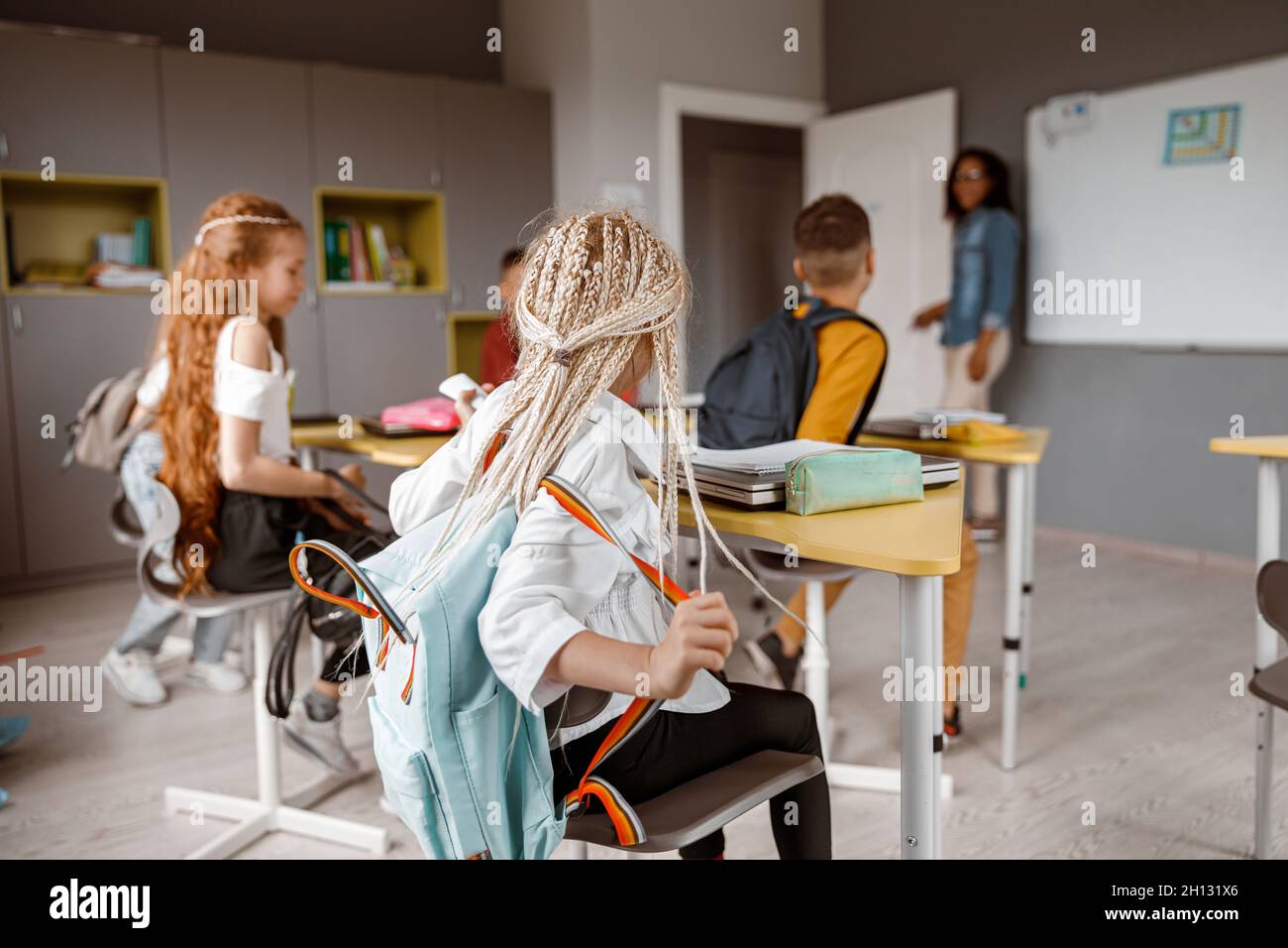 Teacher closing doors at the beginning of the lesson Stock Photo - Alamy
