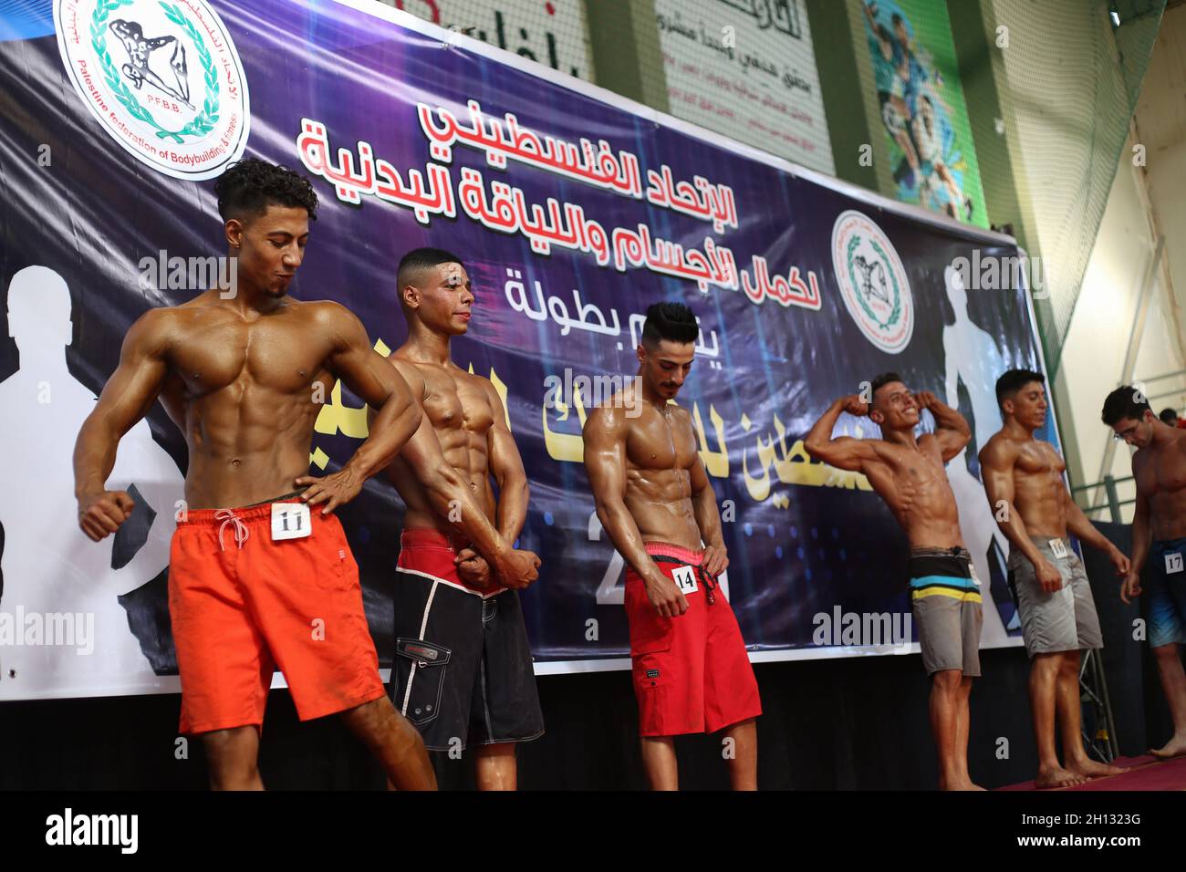 Athletes display their body muscles during the championship.The ...