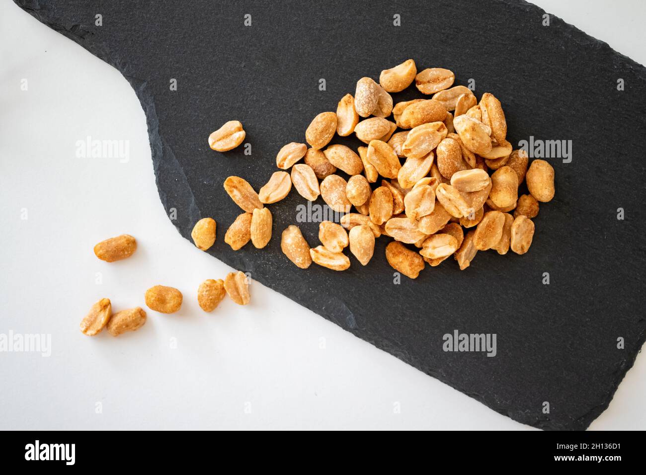 Chili lemon peanuts on stone cutting board Stock Photo - Alamy