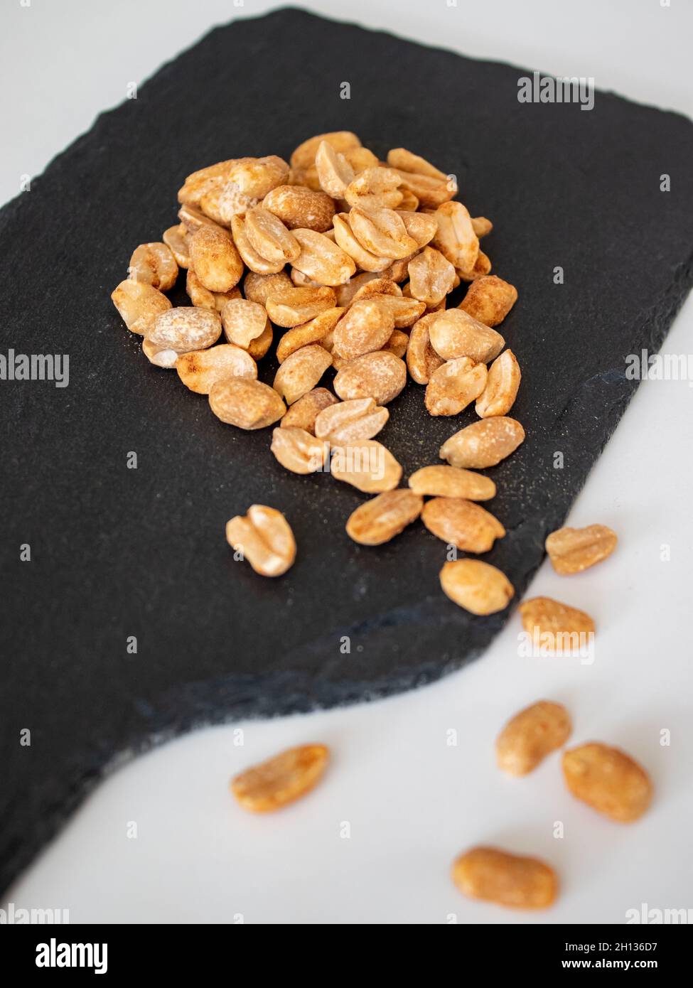 Chili lemon peanuts on stone cutting board Stock Photo - Alamy