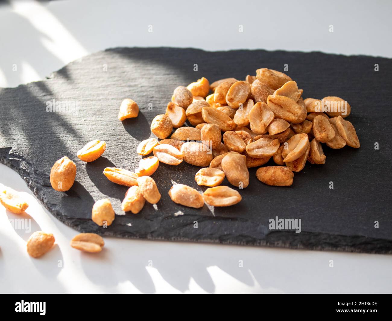 Chili lemon peanuts on stone cutting board Stock Photo - Alamy