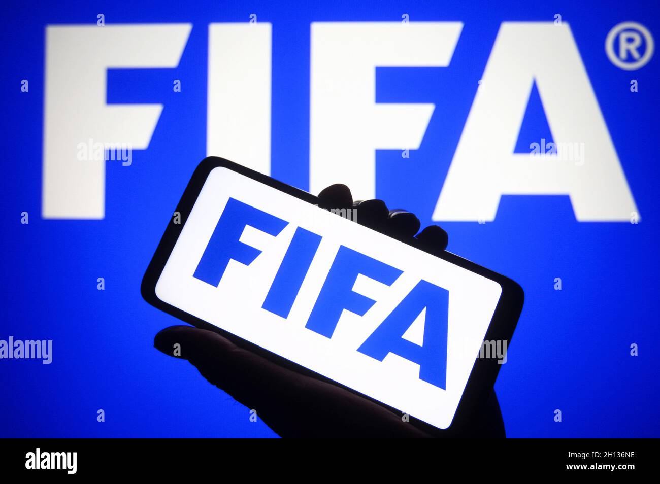 In this photo illustration, FIFA logo is seen on a smartphone in a hand ...