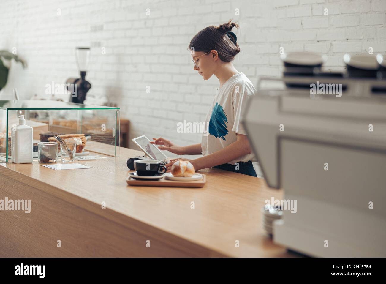 Charming young woman preparing order for customer in coffeehouse Stock ...