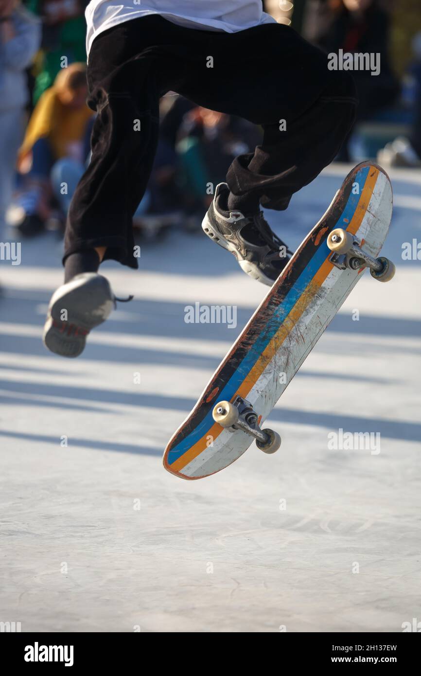 Teenager skater girl jumping on skateboard doing flip on skate contest ...
