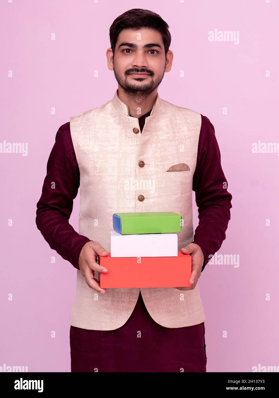 Handsome indian man in Traditional wear holding gift boxes in hand in ...