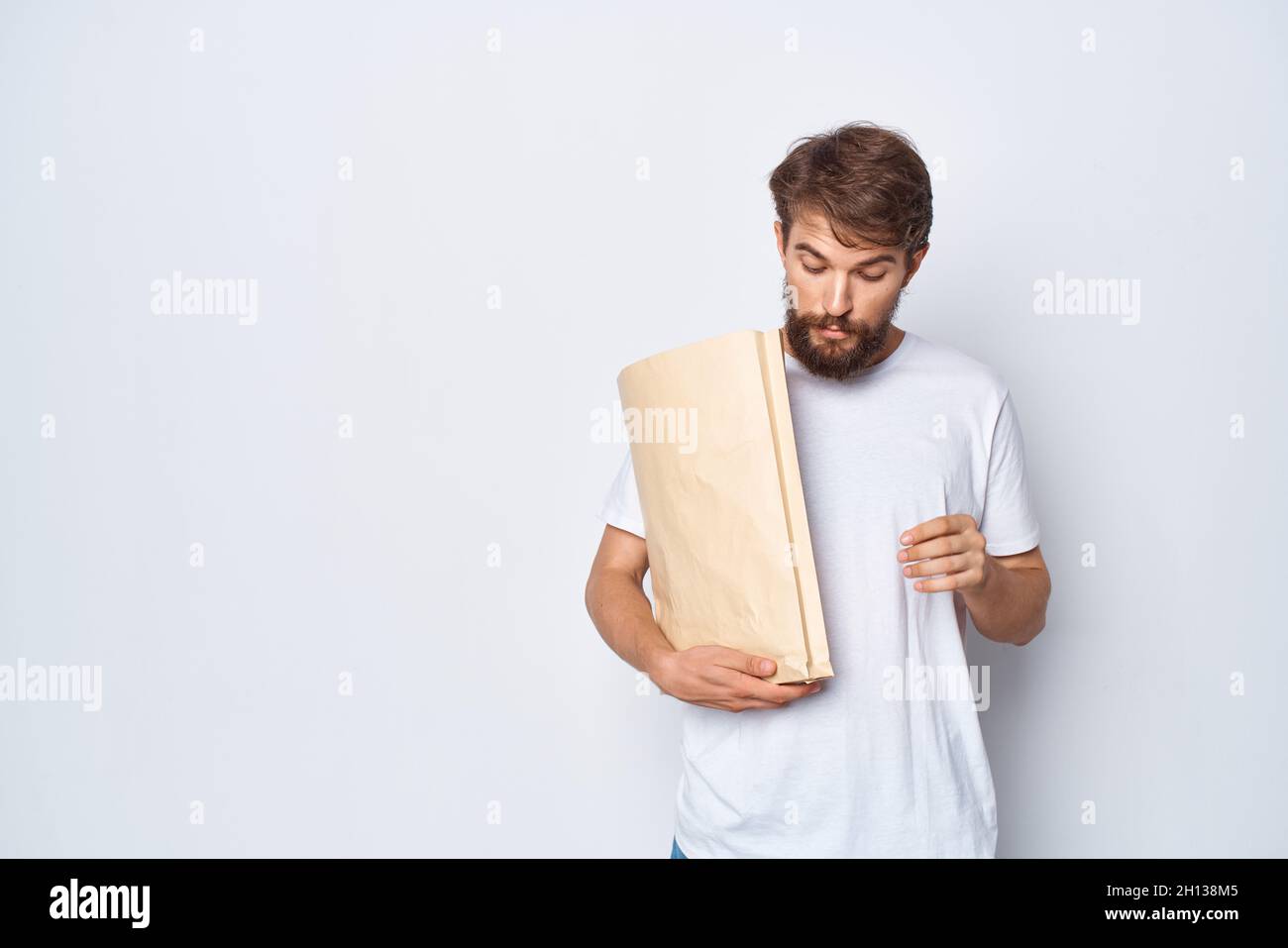 man with package in hands packing shopping isolated background Stock ...