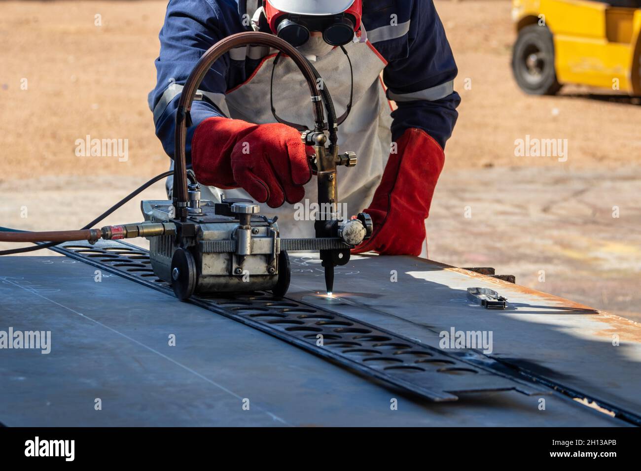 Motswana welder worker in a Botswana workshop, using an acetylene torch ...