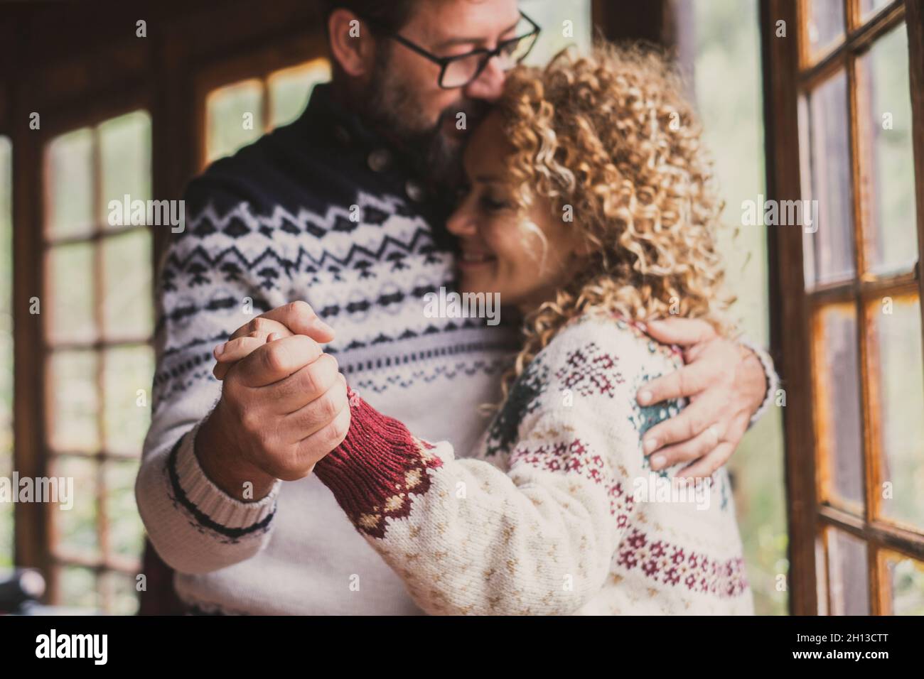 Romantic adult couple dancing at home with love and relationship. Man ...