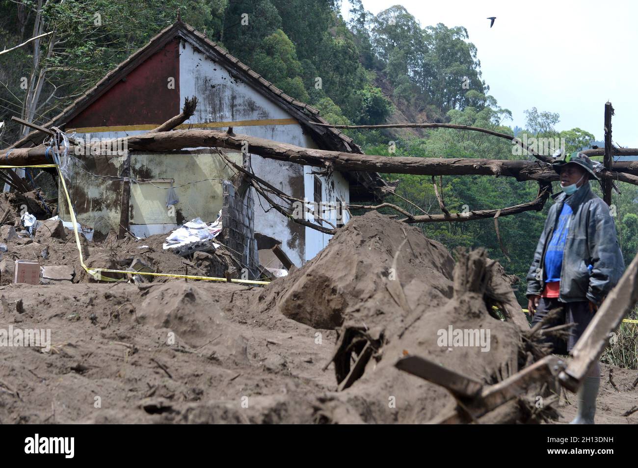 Bali, Indonesia. 16th Oct, 2021. A man stands near a damaged house ...