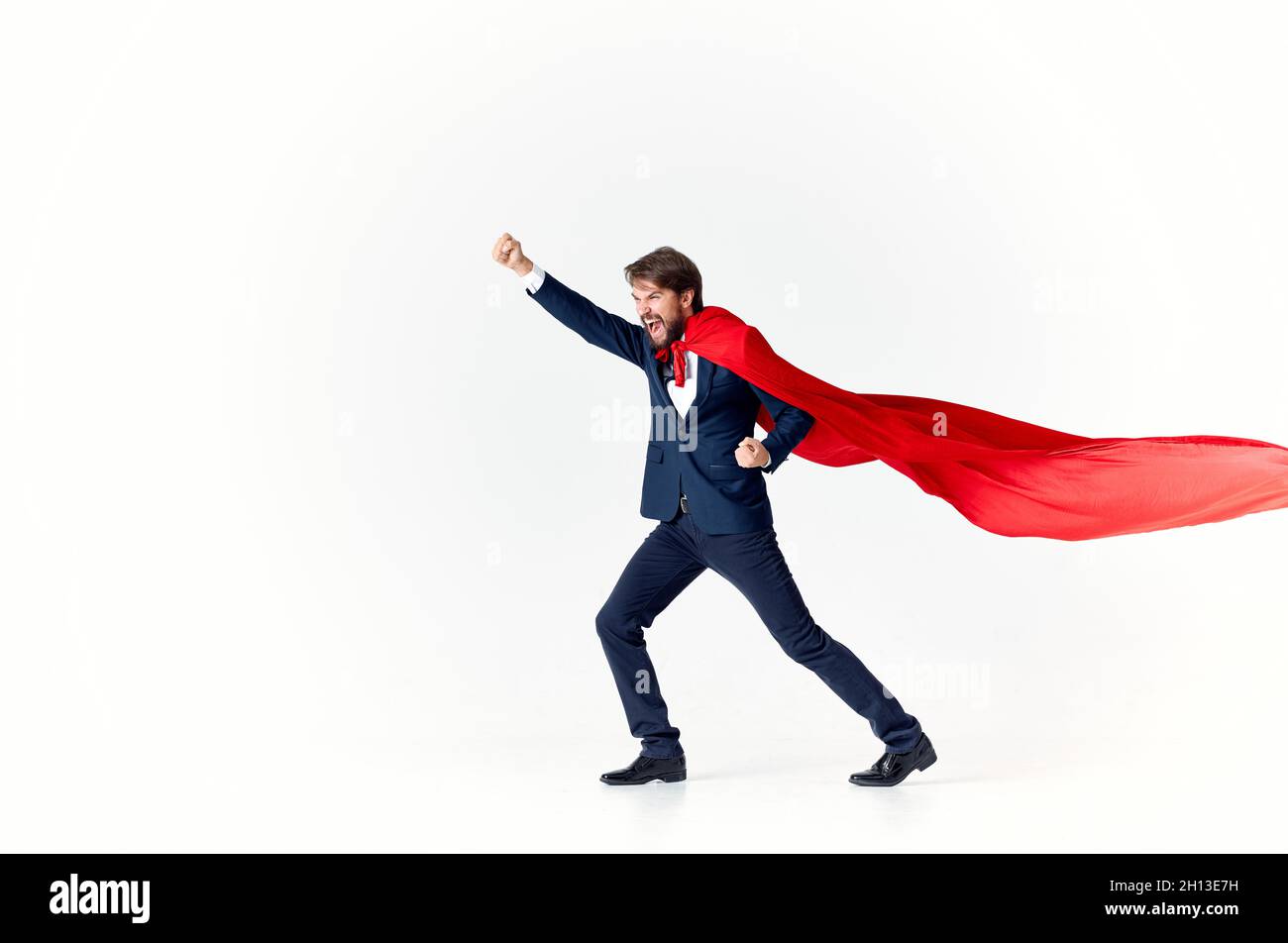 man in suit with red cloak hold hand above head superhero light ...