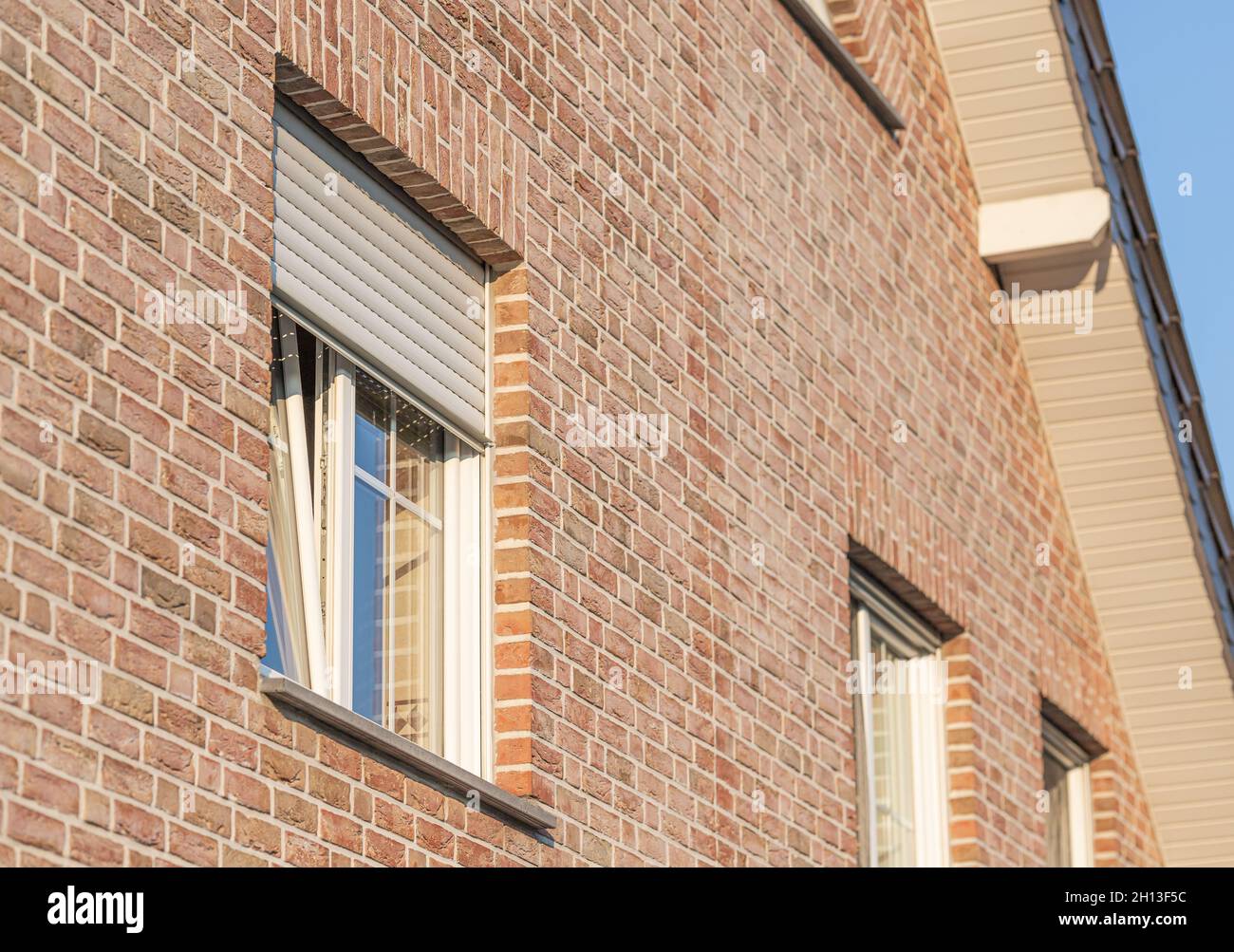 Wall of the red brick house with windows Stock Photo - Alamy