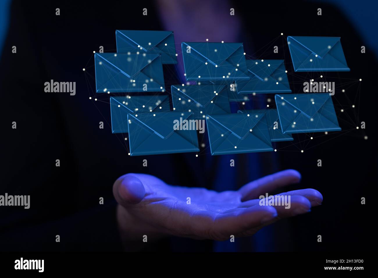 Abstract shot of a man's hand showing 3D rendered digital email and ...