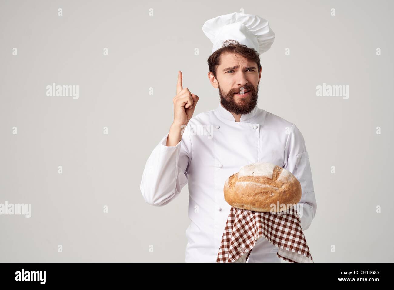 Chef with bread in hand isolated background Stock Photo - Alamy