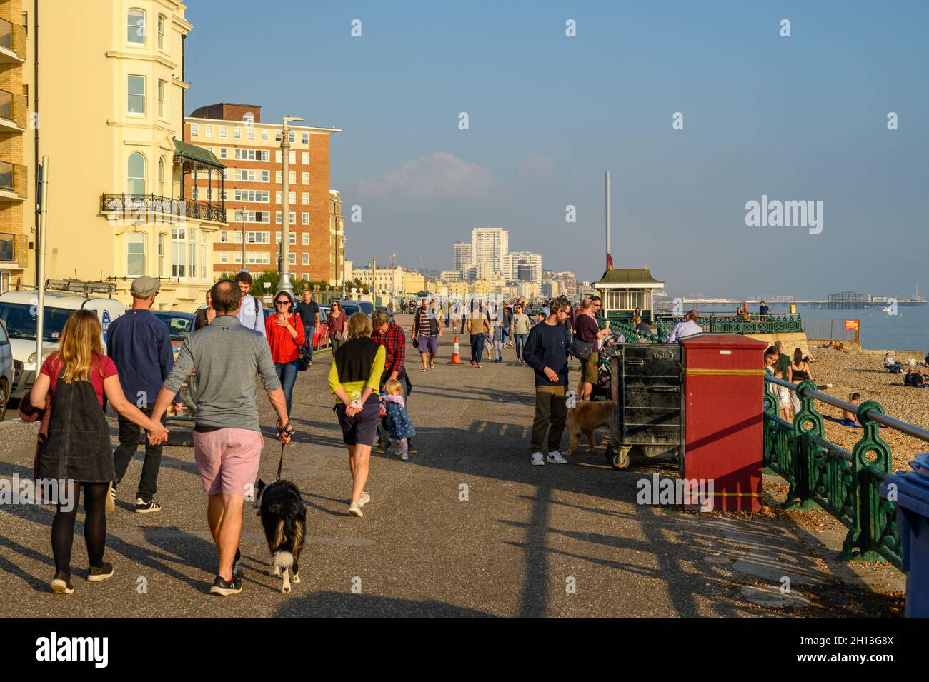 People strolling on Hove promenade in glowing October afternoon ...