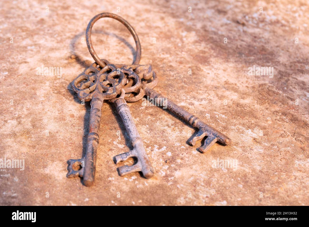 Old rusty key on grunge background. Vintage door keys. Antique keys on ...