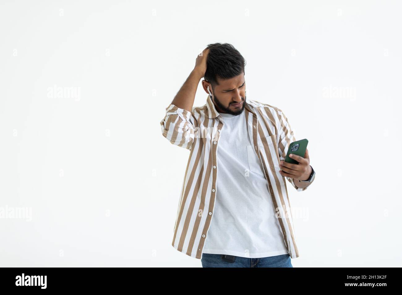 Indian man use phone confused isolated on white background Stock Photo ...