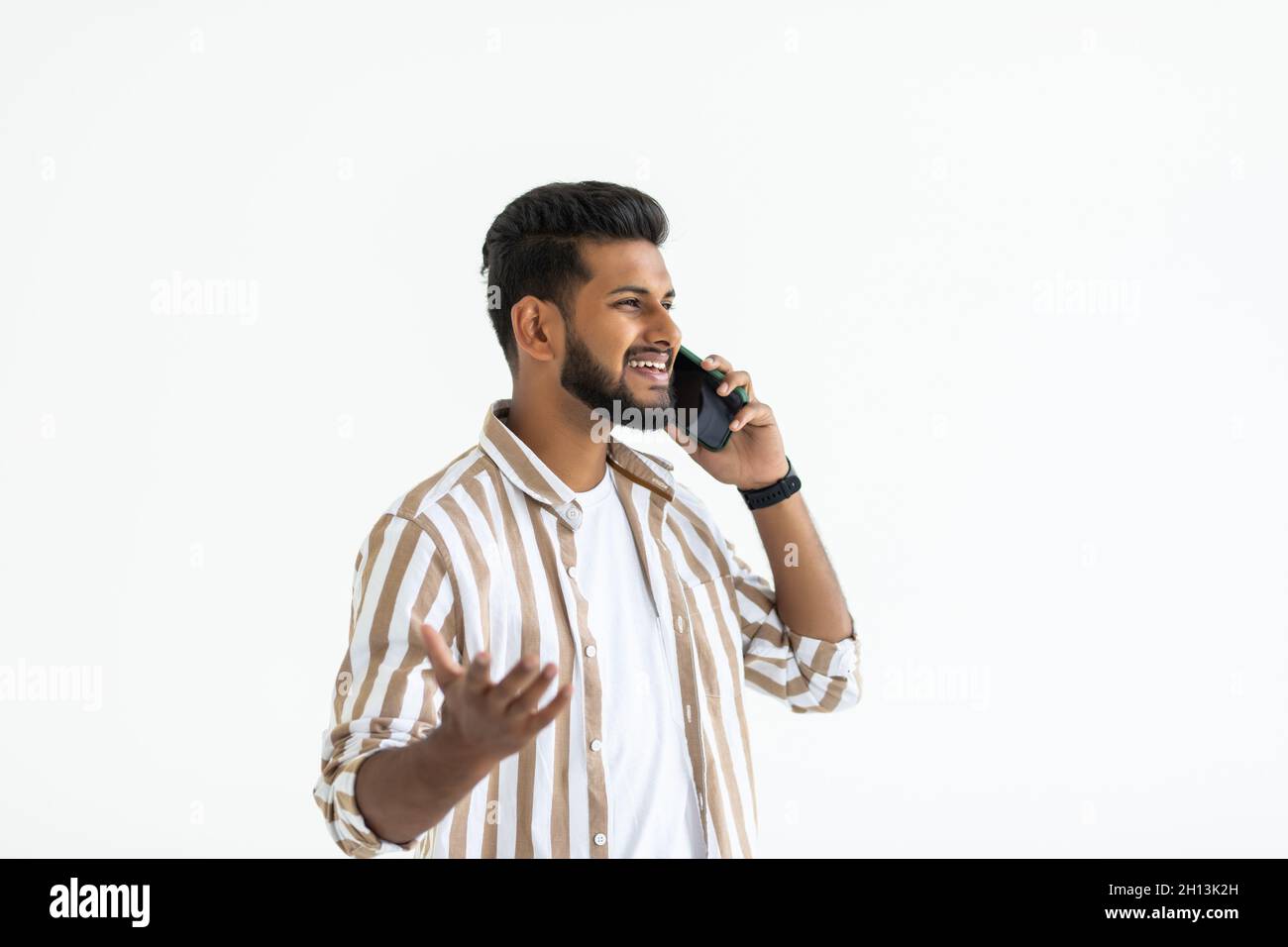 Young handsome Indian man talking on mobile phone Stock Photo - Alamy