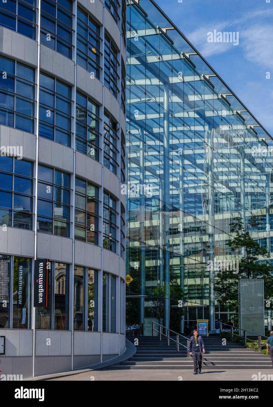 A man walks outside Tower Place, a mixed-use building complex in London ...