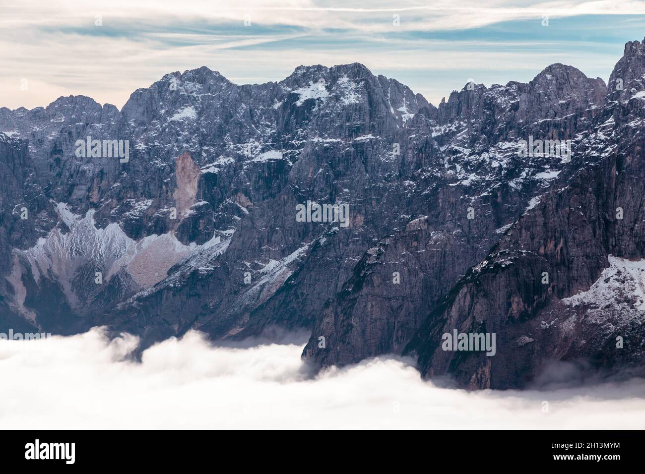 Clouds in the valley under the peak of Julian Alps Stock Photo - Alamy