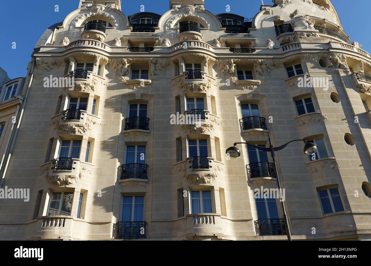 The facade of traditional French house with typical balconies and ...
