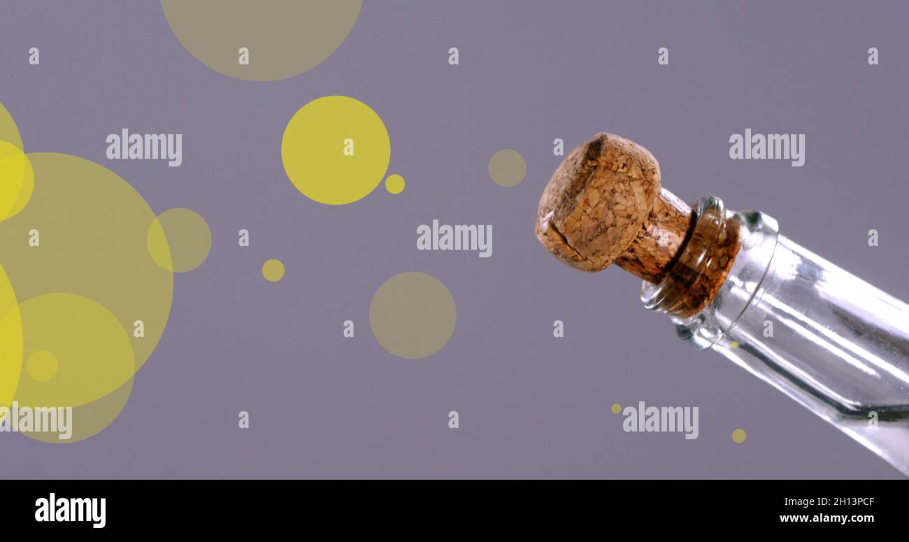 Image of glowing yellow spots falling over champagne cork exploding ...