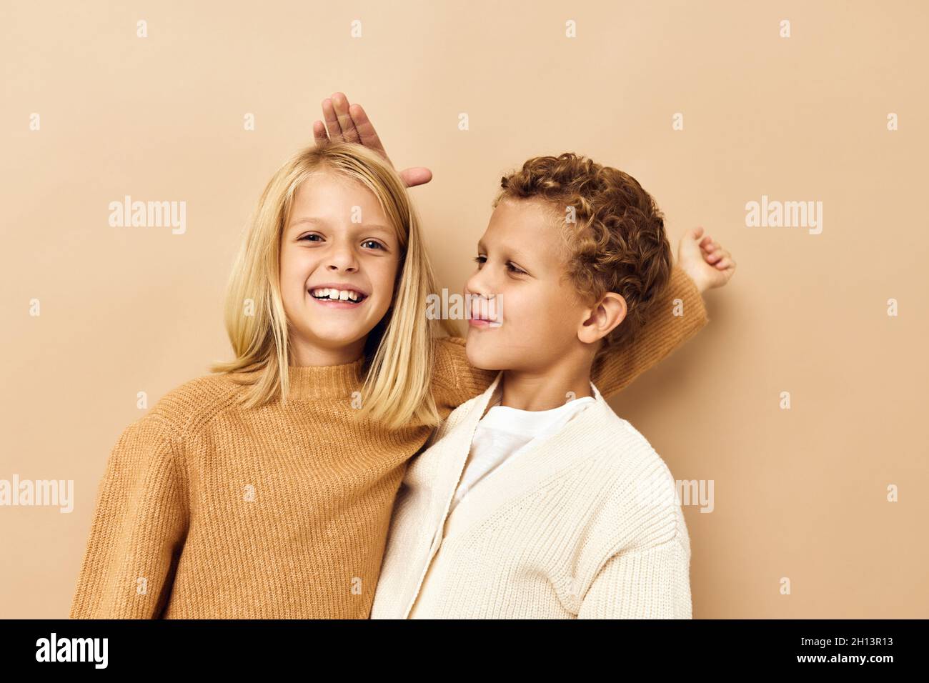 happy children stand side by side isolated background Stock Photo - Alamy