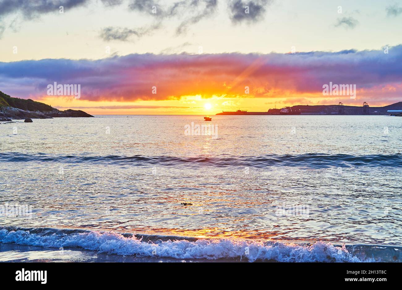 Mesmerizing view of multicolor sunset on the sea from the sandy beach ...
