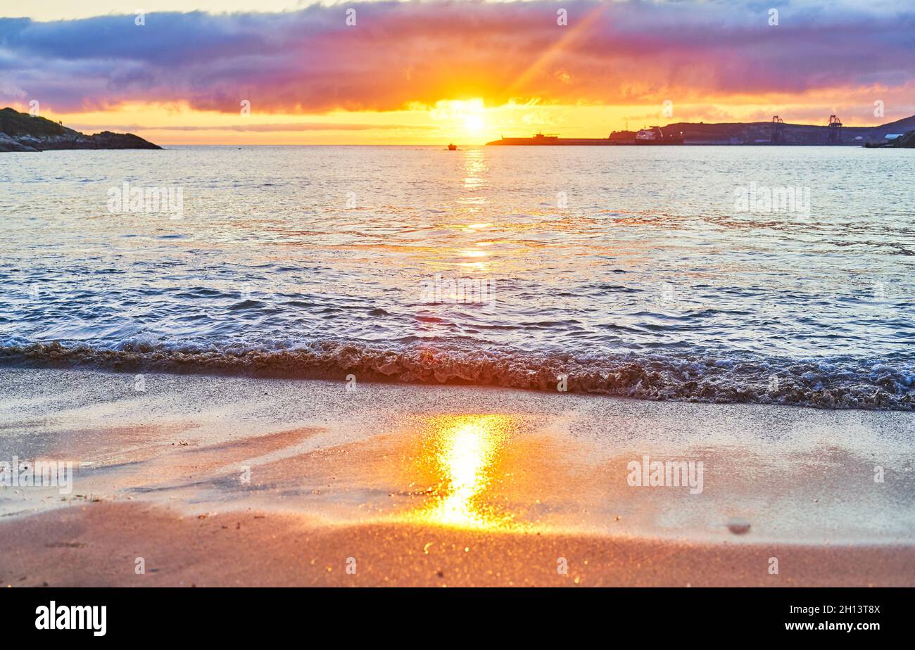 Mesmerizing view of multicolor sunset on the sea from the sandy beach ...