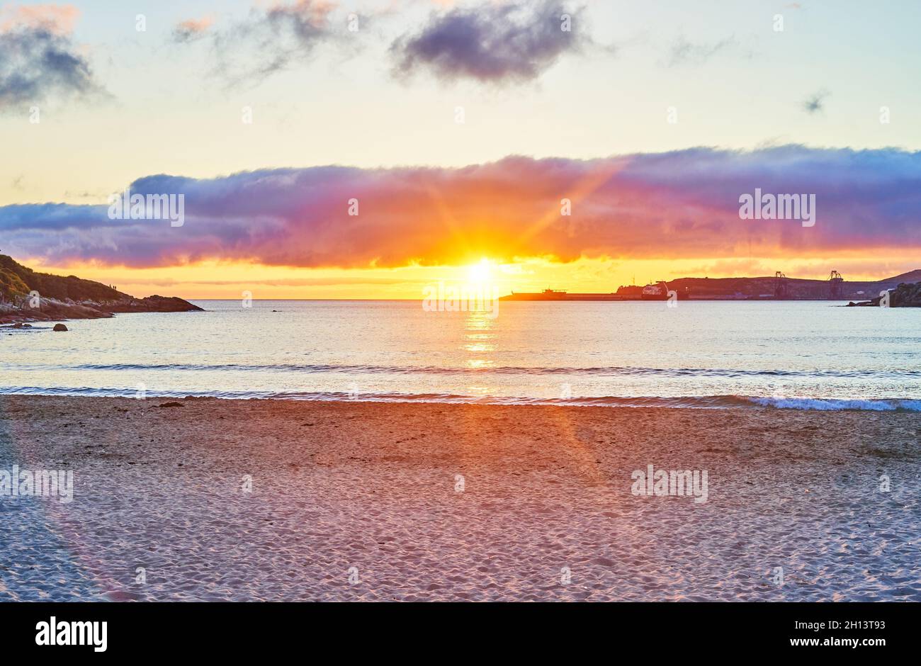 Mesmerizing view of multicolor sunset on the sea from the sandy beach ...