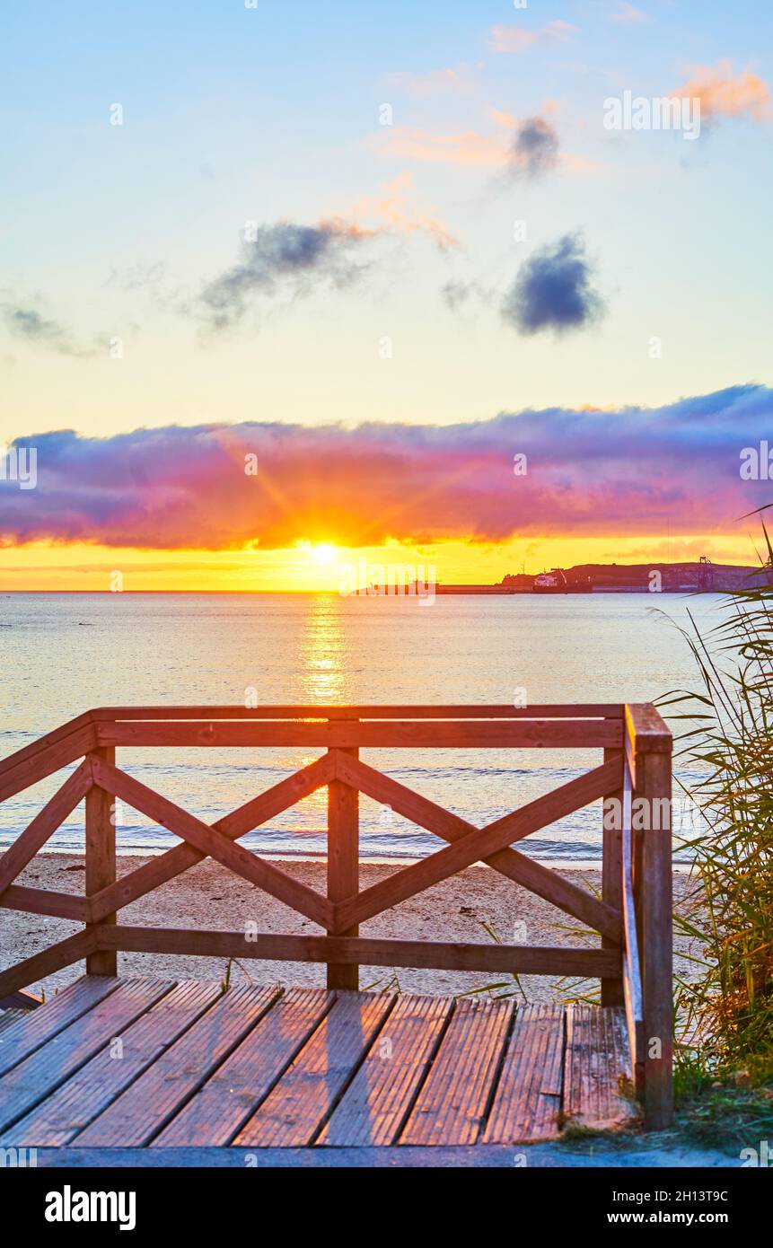 Mesmerizing view of multicolor sunset on the sea from the sandy beach ...