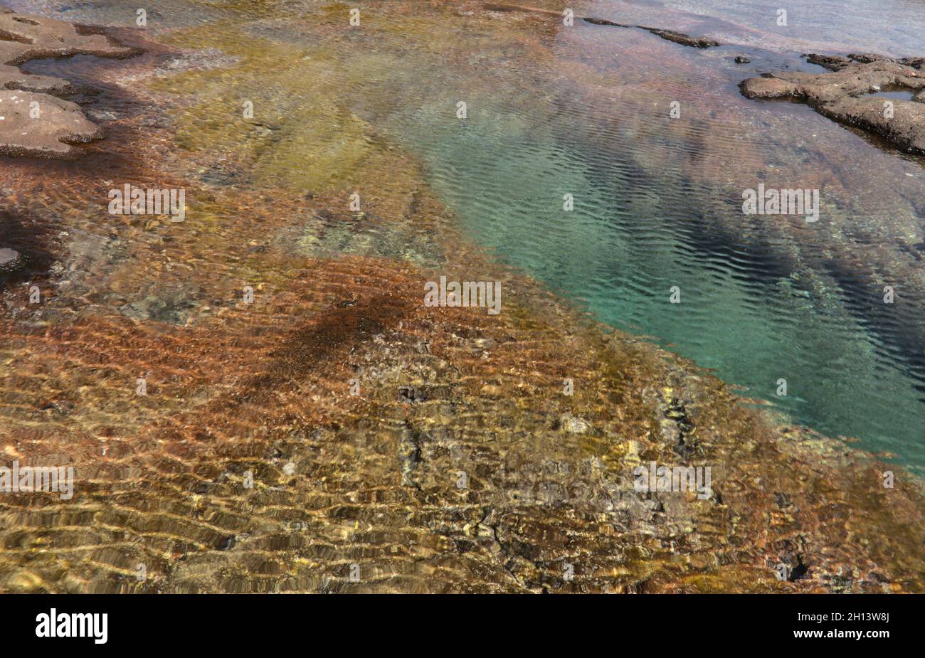 Gran Canaria, calm rock pools under steep cliffs of the north coast are ...