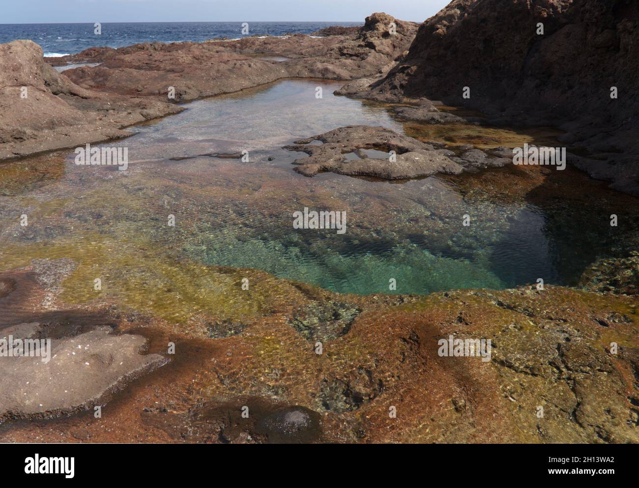 Gran Canaria, calm rock pools under steep cliffs of the north coast are ...