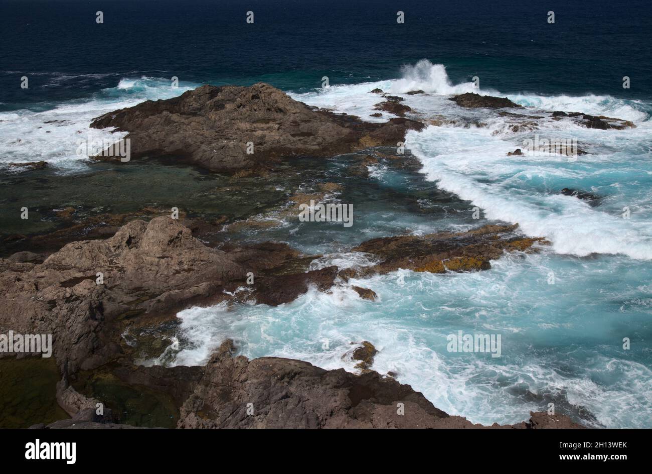 Gran Canaria, calm rock pools under steep cliffs of the north coast are ...