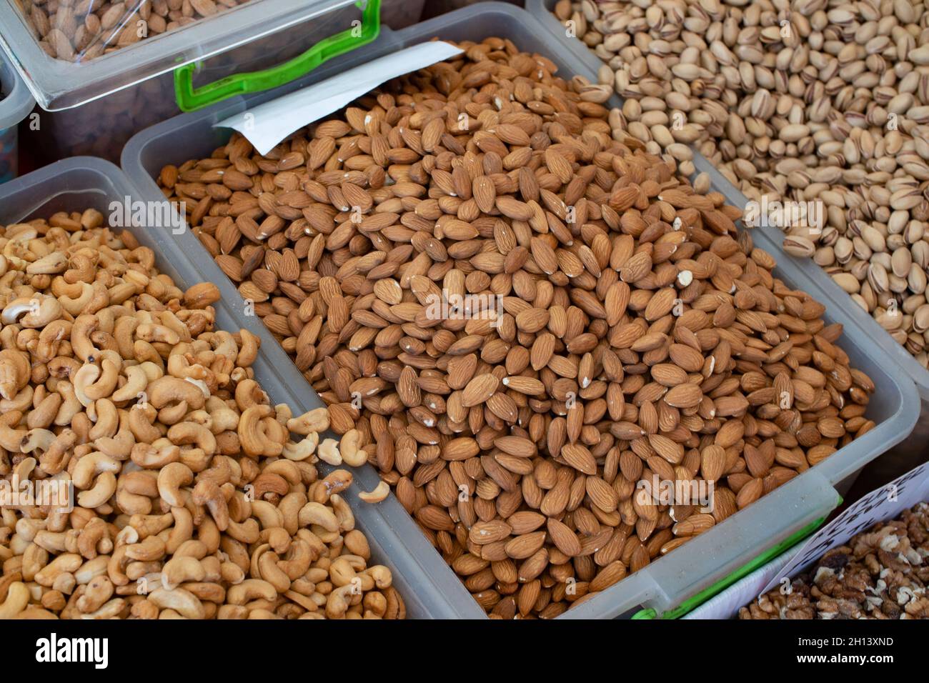 Different nuts: almonds, cashews, pistachios on display at farmer's ...