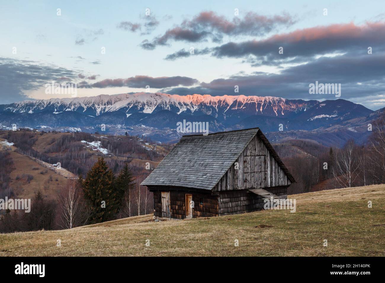 Wooden cottage in a mountain winter landscape. Romania, Bucegi ...