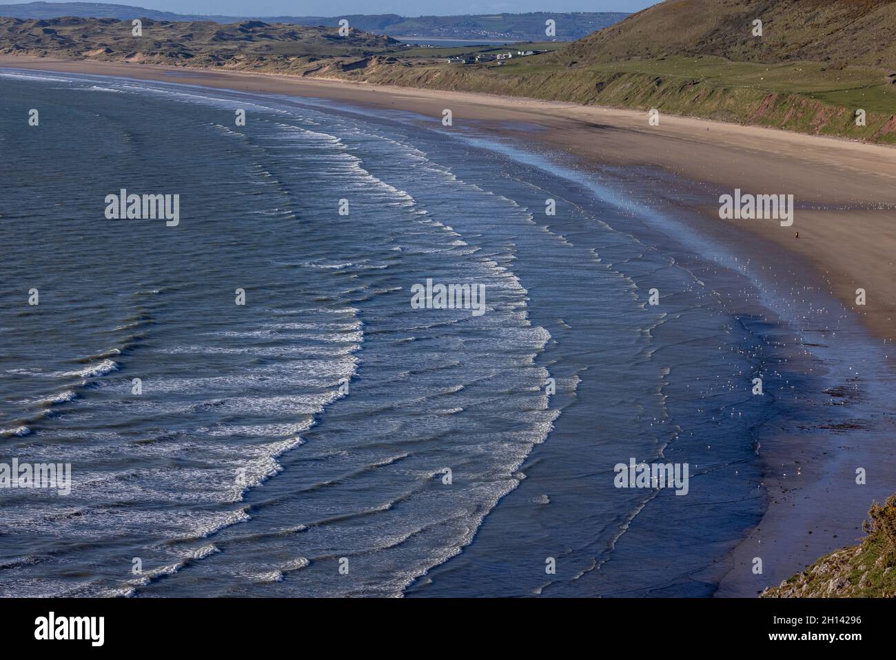 Rhossili Bay, Gower peninsula, with surf, in the evening light. Wales ...