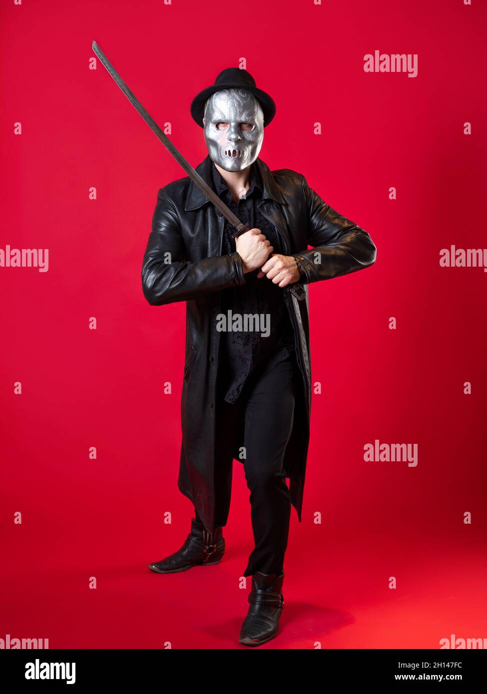 A mysterious ninja assassin in a noir style. A man in black clothes ...